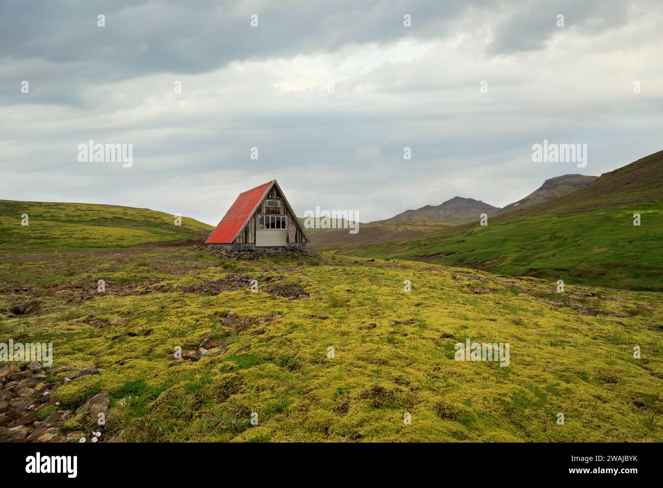 From below of solitary cottage with a red roof stands amidst a vast ...