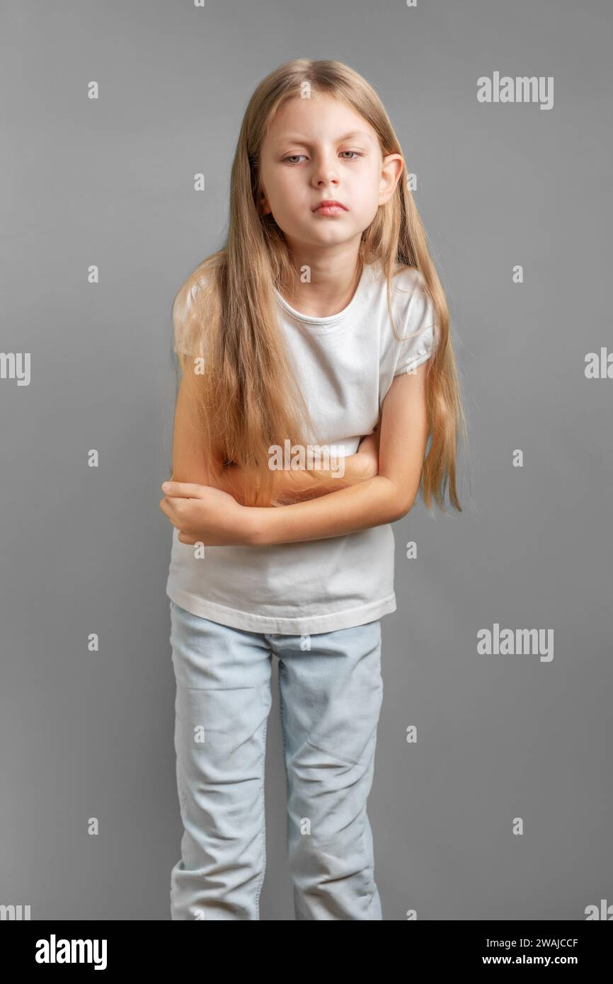 Little girl holding her stomach. Abdominal pain Stock Photo - Alamy