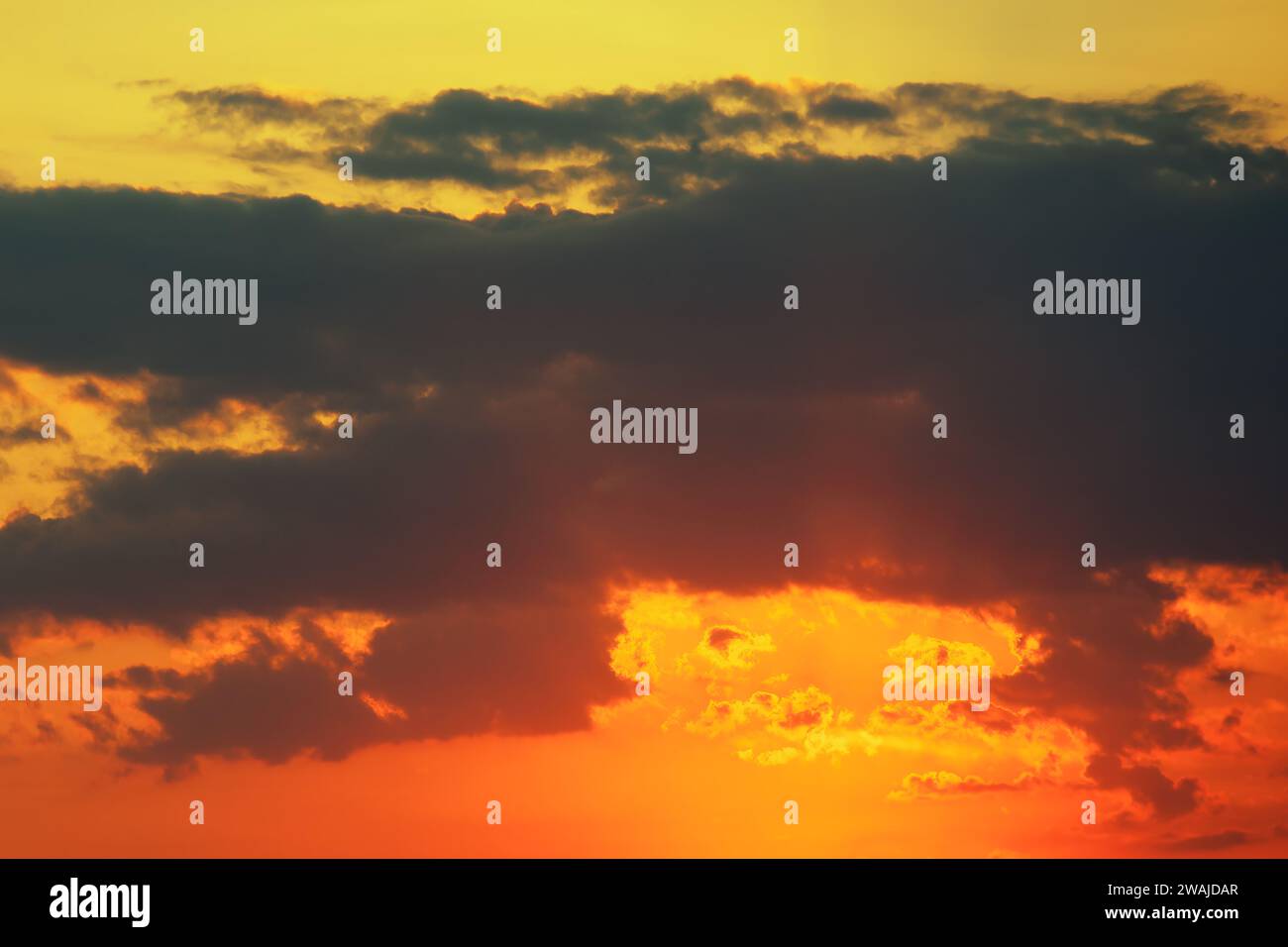 Sunset sky background with tiny clouds and orange sunbeams Stock Photo ...