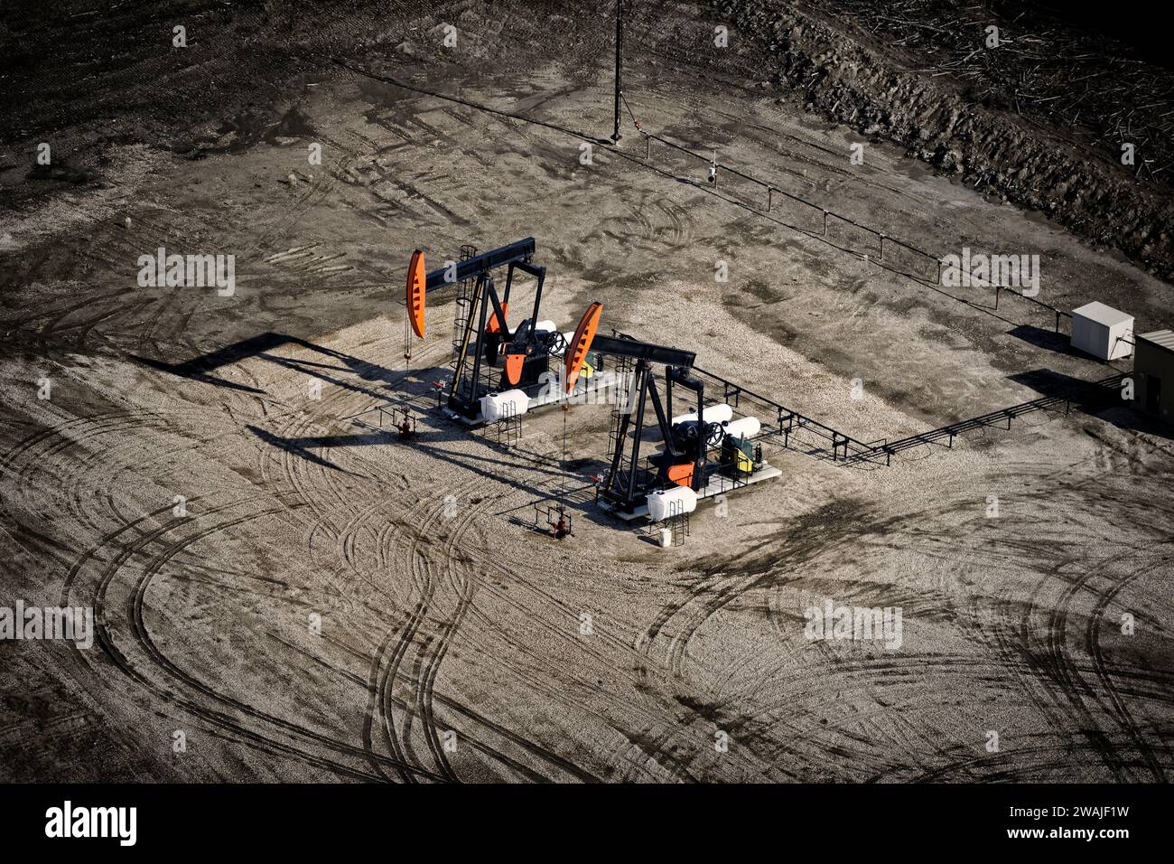 An aerial view of two pumpjacks in operation at an oilfield, extracting ...