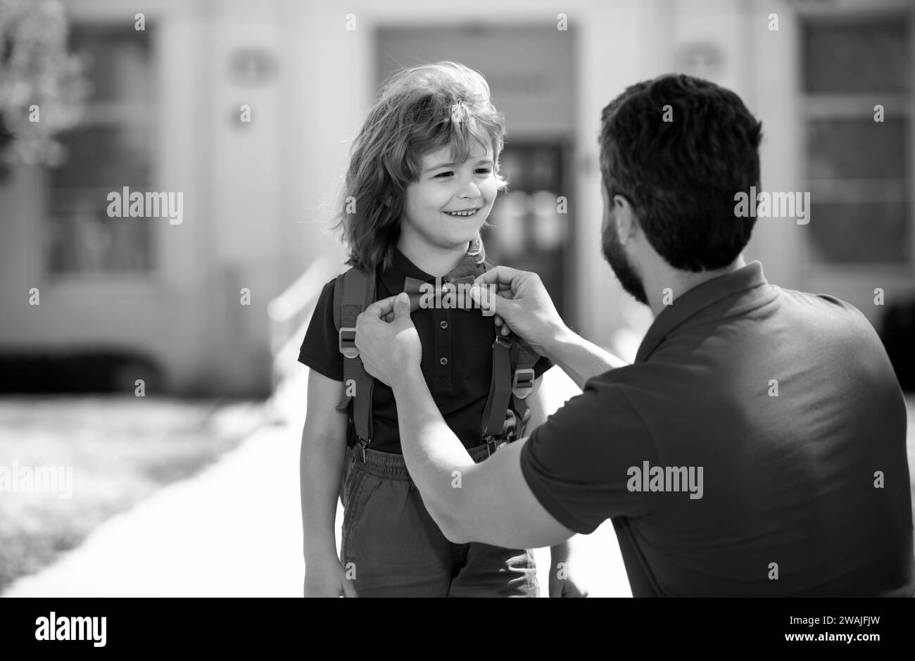 Father saying goodbye to his little child son near school. Kids ...
