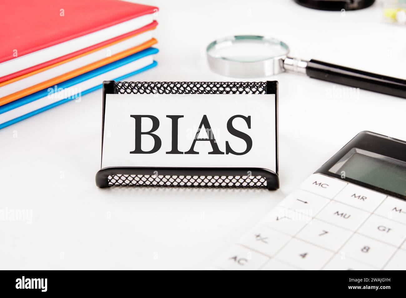 Bias text on a business card next to office supplies on a white ...