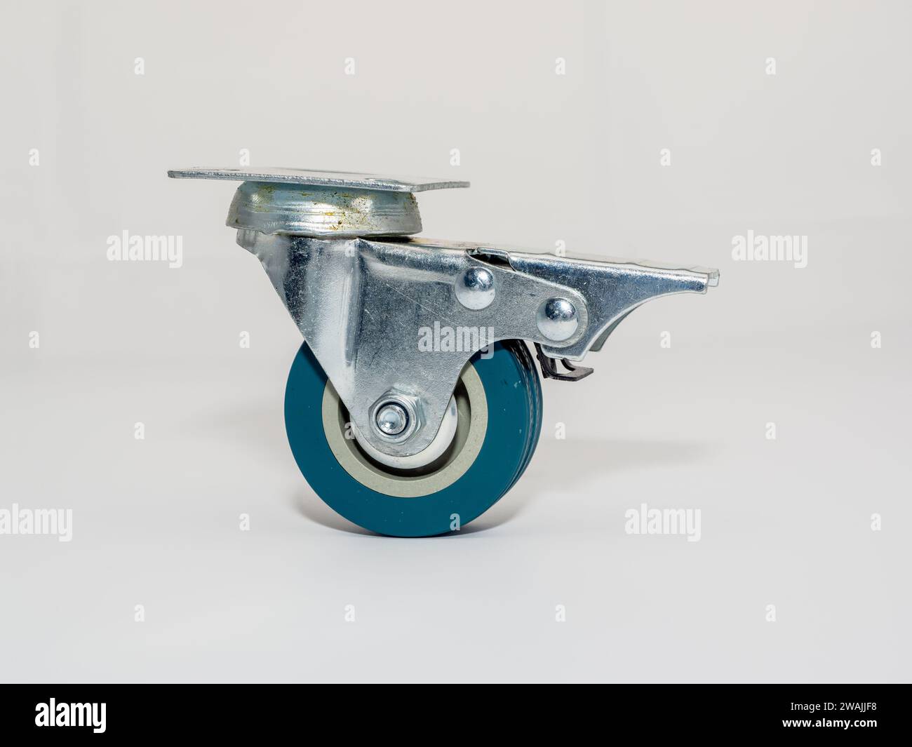 single heavy duty roller castor wheel with brake isolated on a white ...