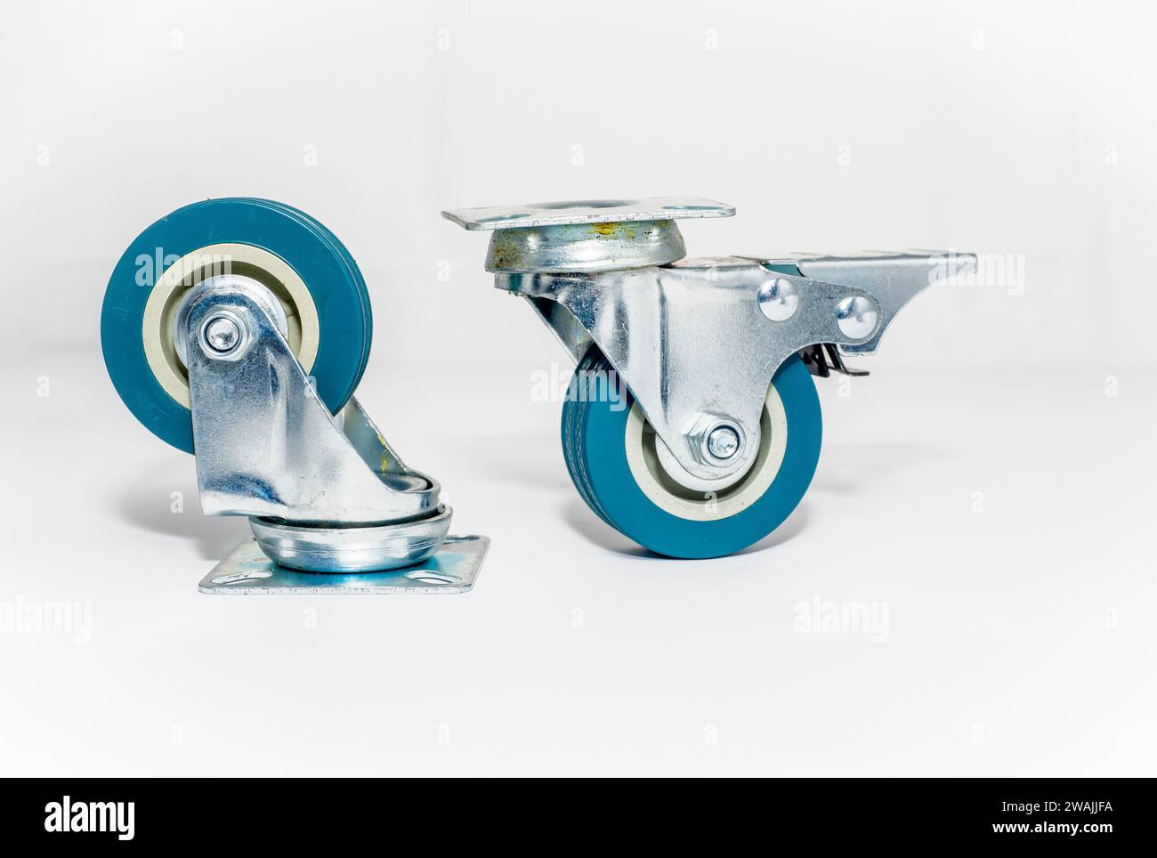 pair of furniture steel roller castors one with brake isolated on a ...