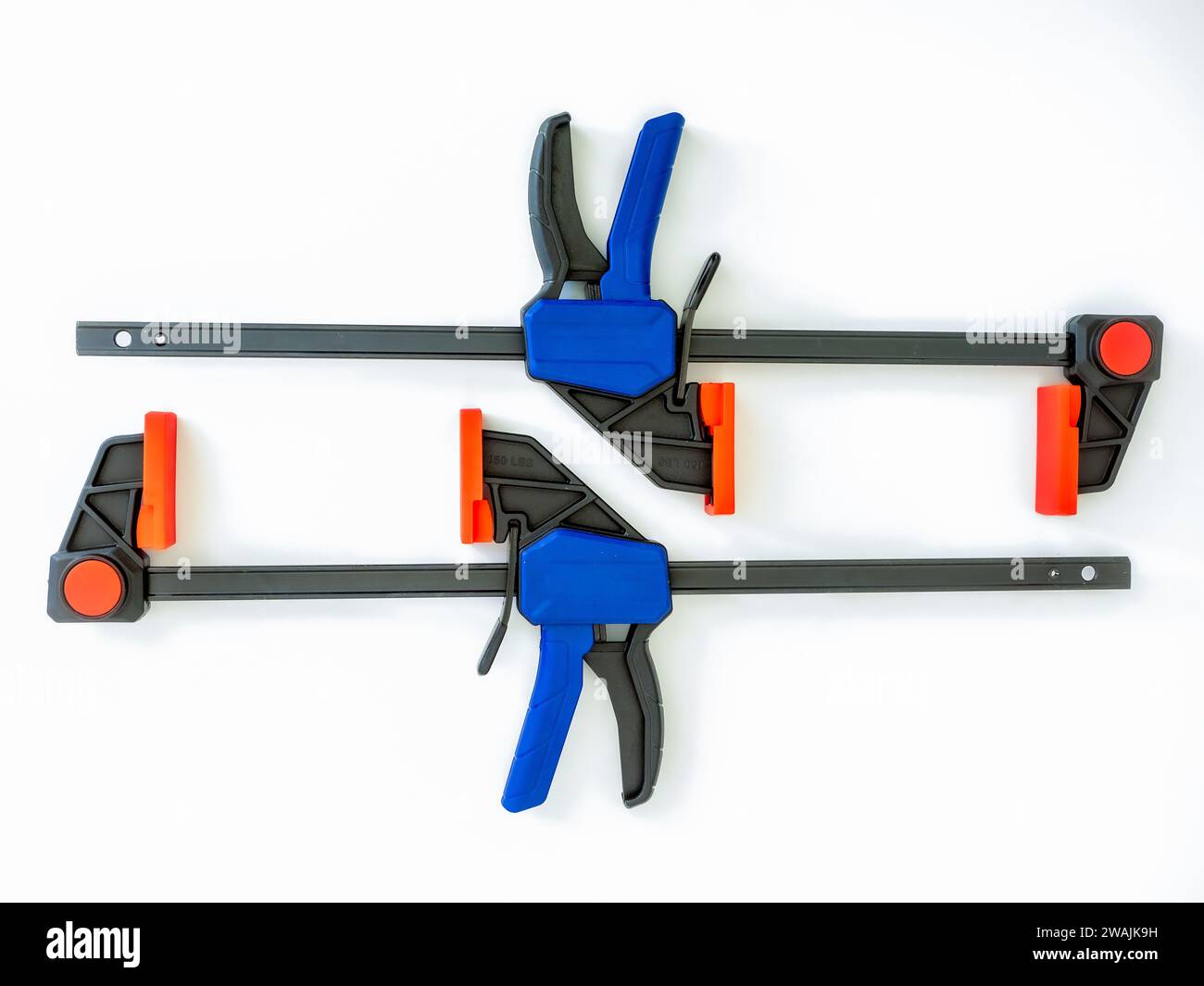 pair of lightweight speed quick release clamps used in woodworking and ...