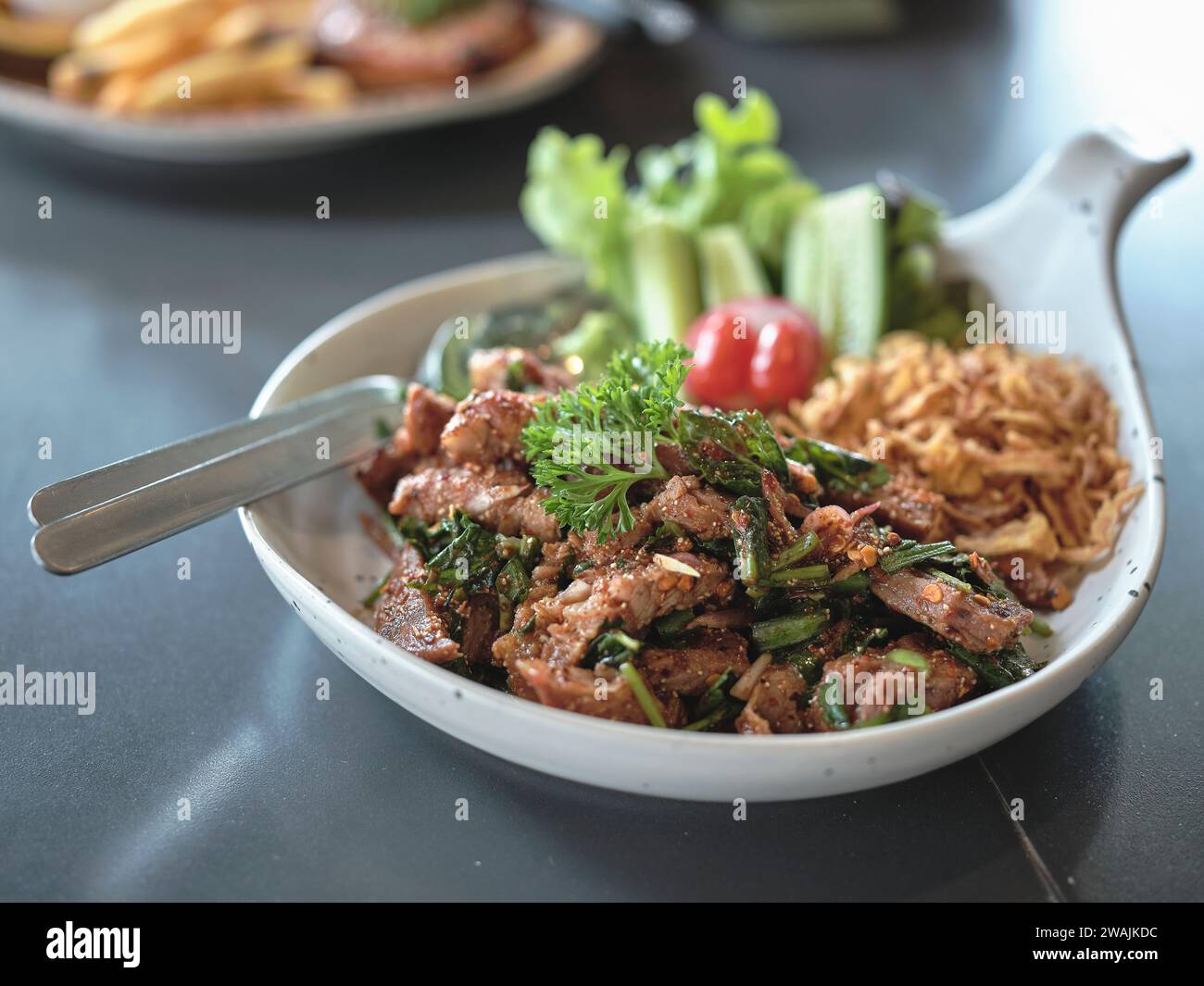 Thai street food.Spicy Grilled Pork Salad,grill pork with Charcoal and ...