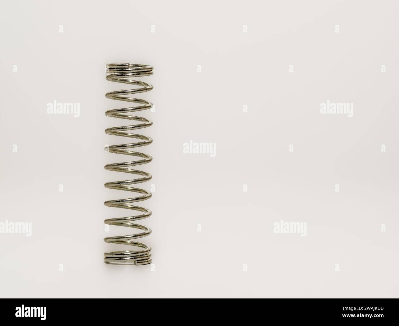 silver steel metal coiled srping isolated on a white background Stock ...