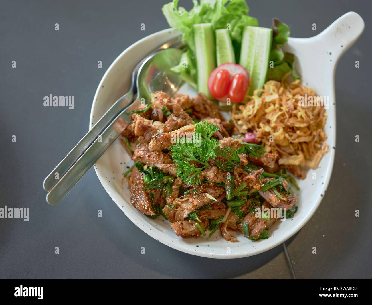 Thai street food.Spicy Grilled Pork Salad,grill pork with Charcoal and ...