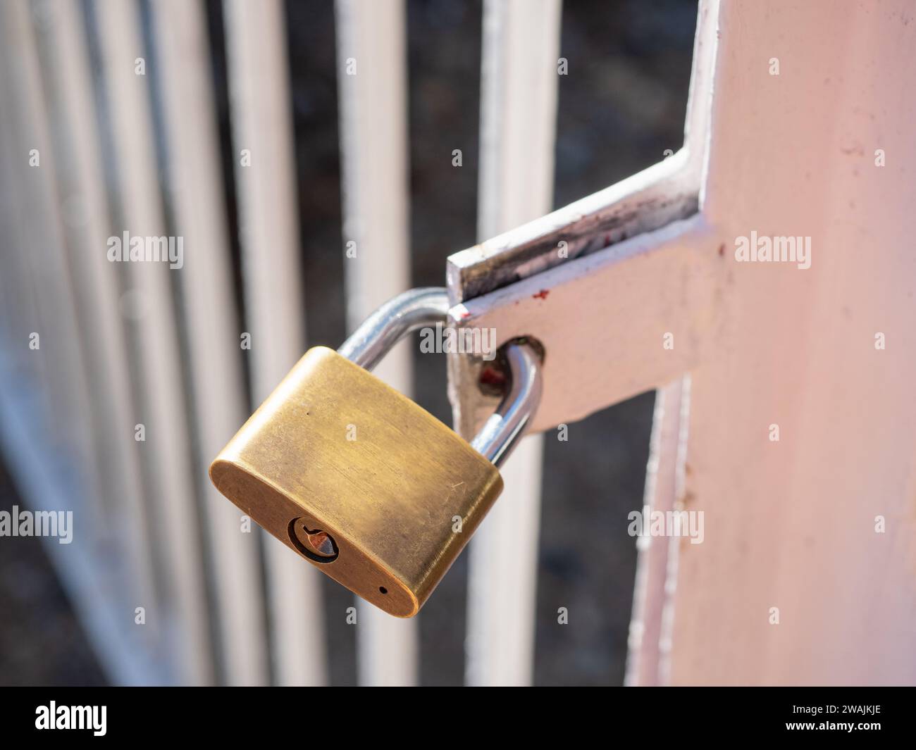 old antique brass and Steel padlock locked wrought iron gates Stock ...