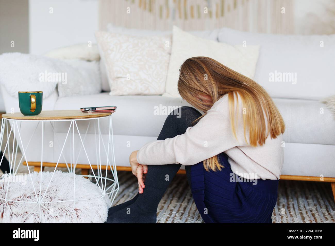 Sad woman hugging knees on hi-res stock photography and images - Alamy