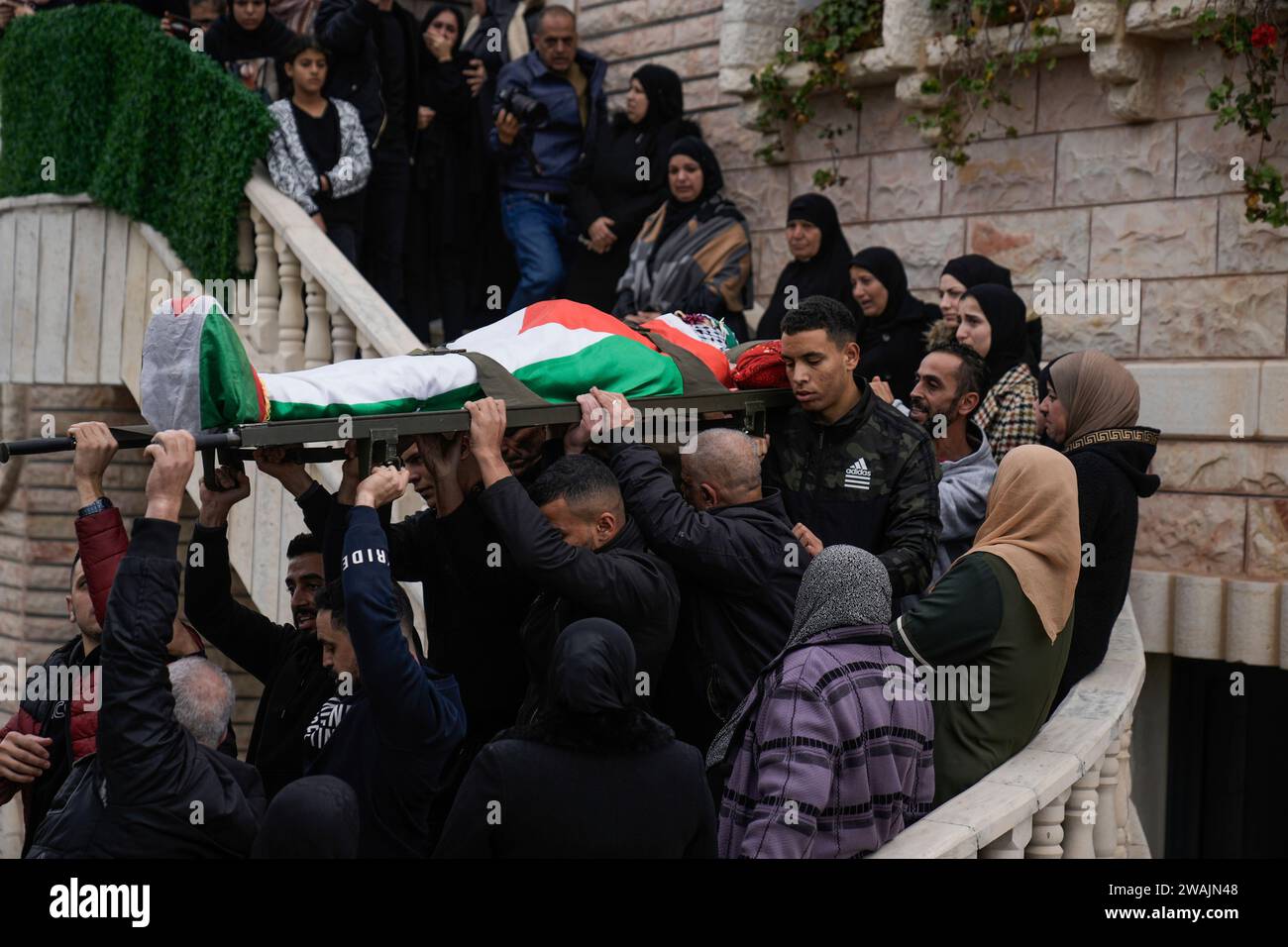 Palestinians carry the body of Aseed Al-Rimawi during his funeral in ...