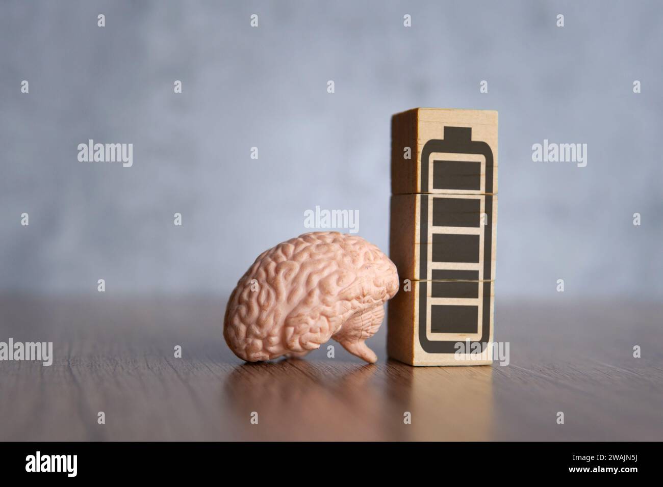 Closeup image of brain and wooden blocks with full energy battery icon ...
