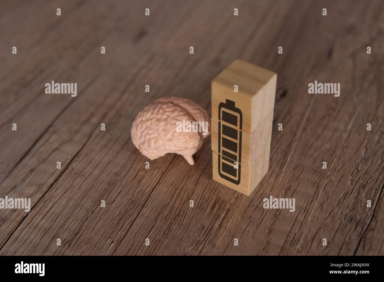 Closeup image of brain and wooden blocks with full energy battery icon ...