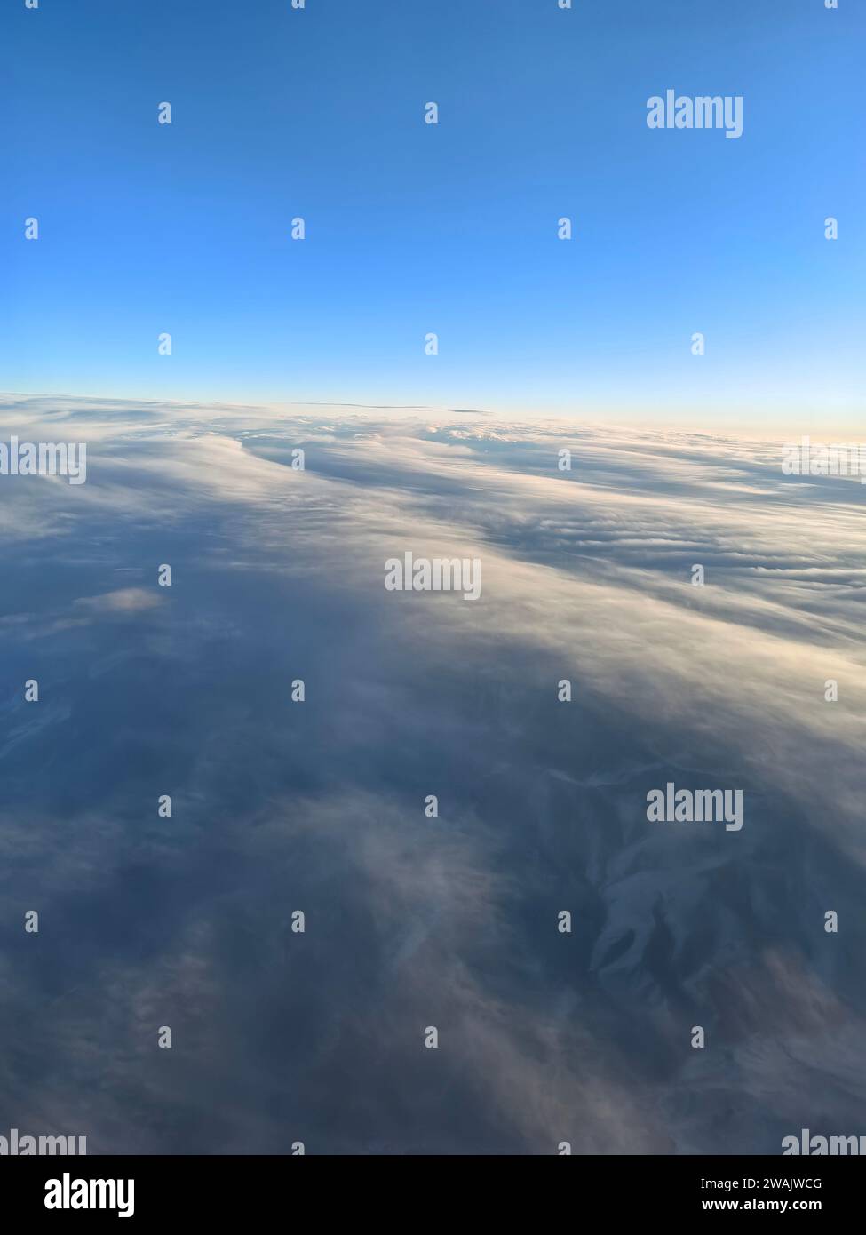 View from airplane at clouds, under clouds of mountains Stock Photo - Alamy