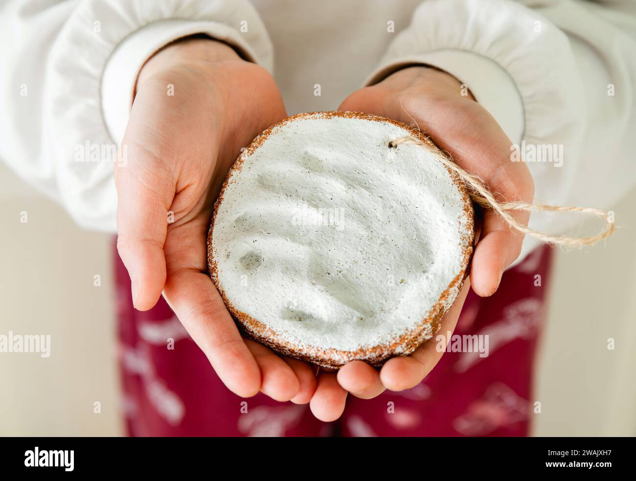 Girl child holding herself handmade baby hand print inside clay for ...