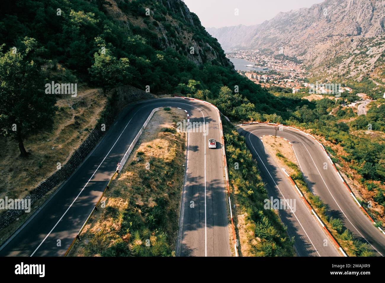 Car is driving along a serpentine road in the mountains above the Bay ...