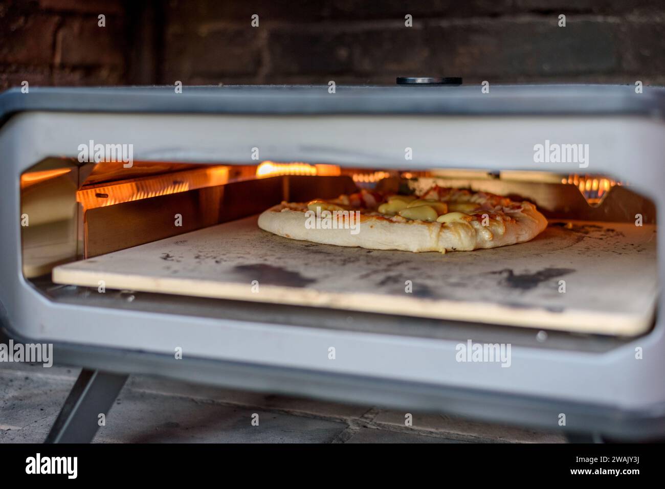 A freshly made pizza inside a brick oven for baking Stock Photo - Alamy