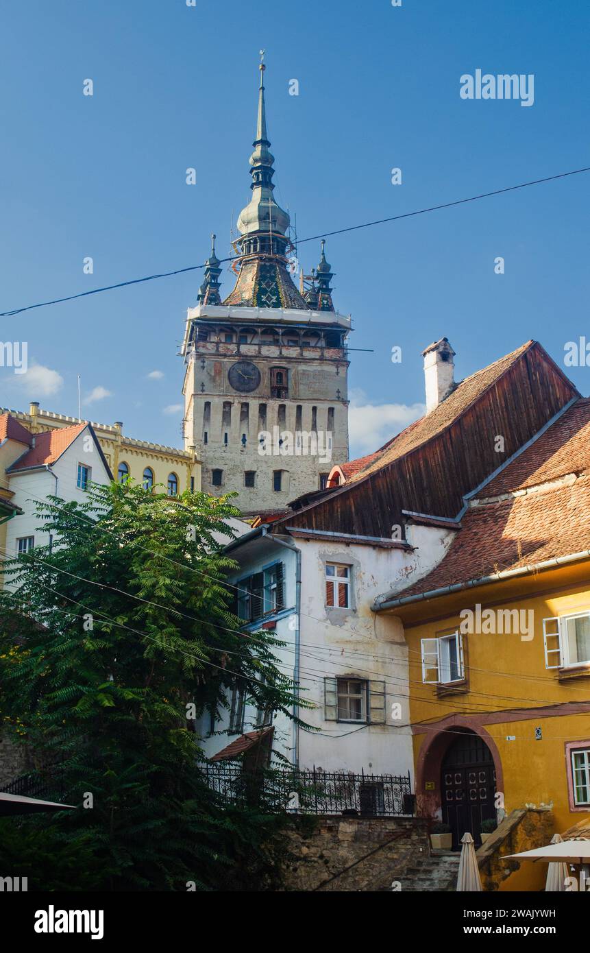 Historical old medieval clock tower surrounded by yellow and white ...