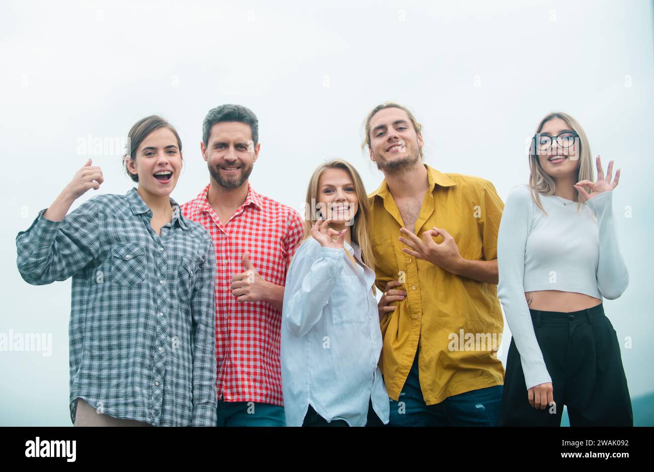 Smiling group of friends laughing with thumb up. Company students best ...