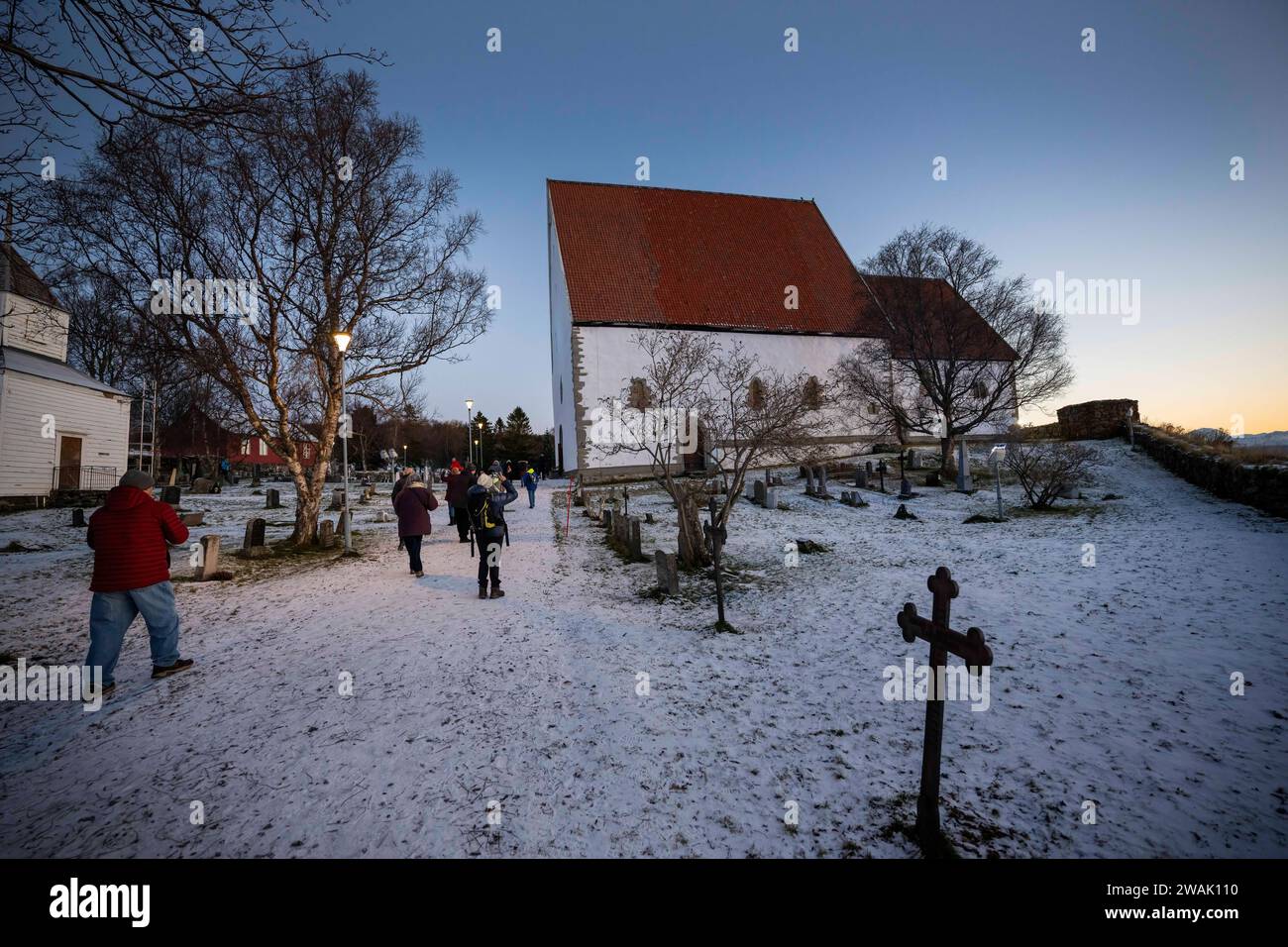 People walk near the grounds of the medieval church of Tondenes, built ...