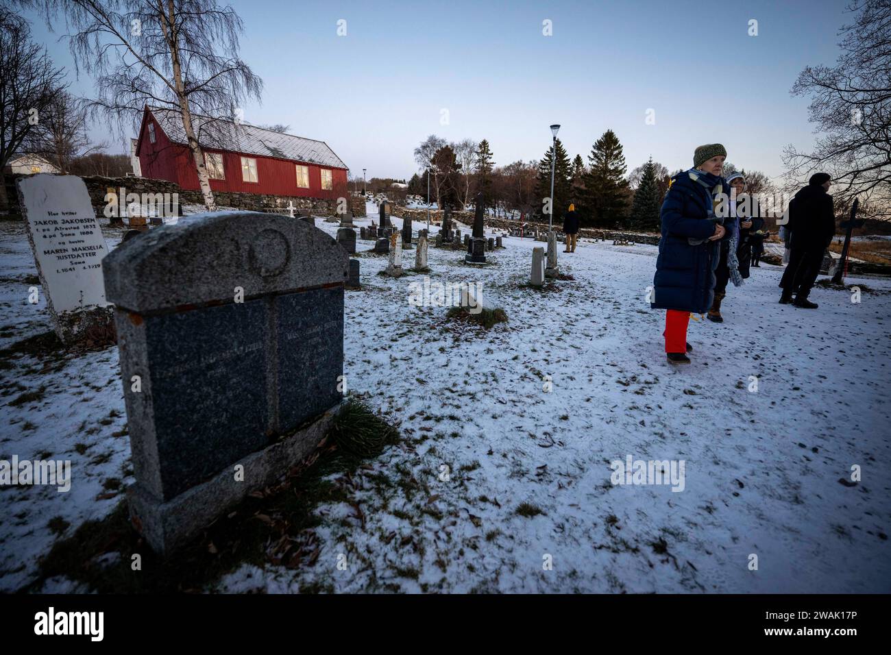 Trondenes, Norway. 13th Nov, 2023. People walk near a cemetery located ...