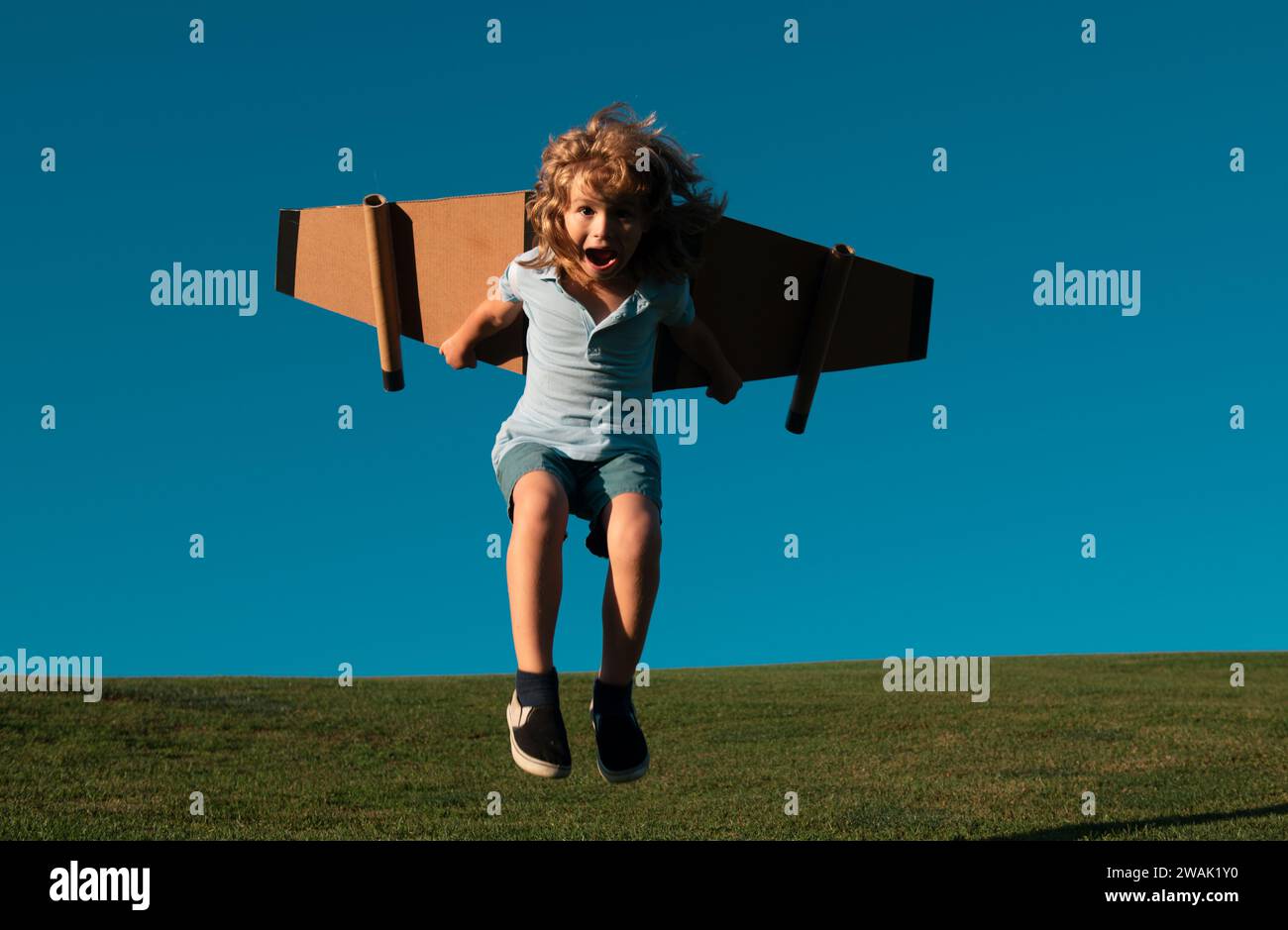 Funny Child jumping and running with toy jetpack. Child pilot astronaut ...