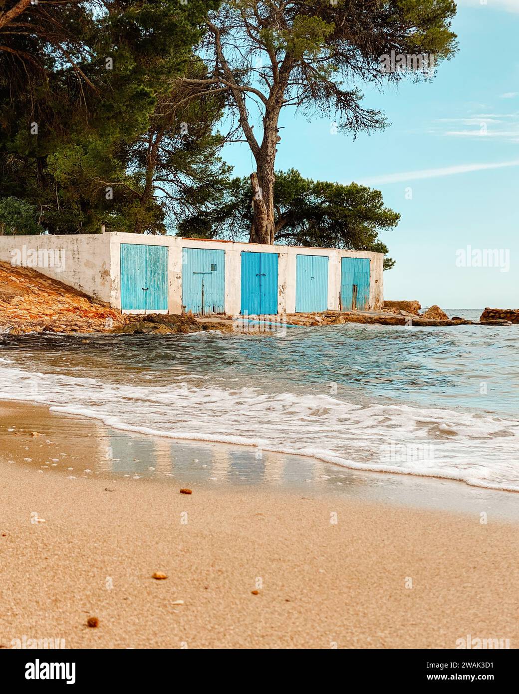 The calm sea and beautiful fishermen's huts at Beach Cala Pada, Ibiza ...
