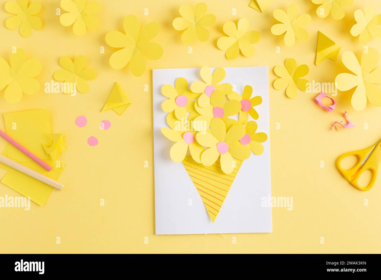 Making simple yellow paper flowers with kids diy Stock Photo - Alamy