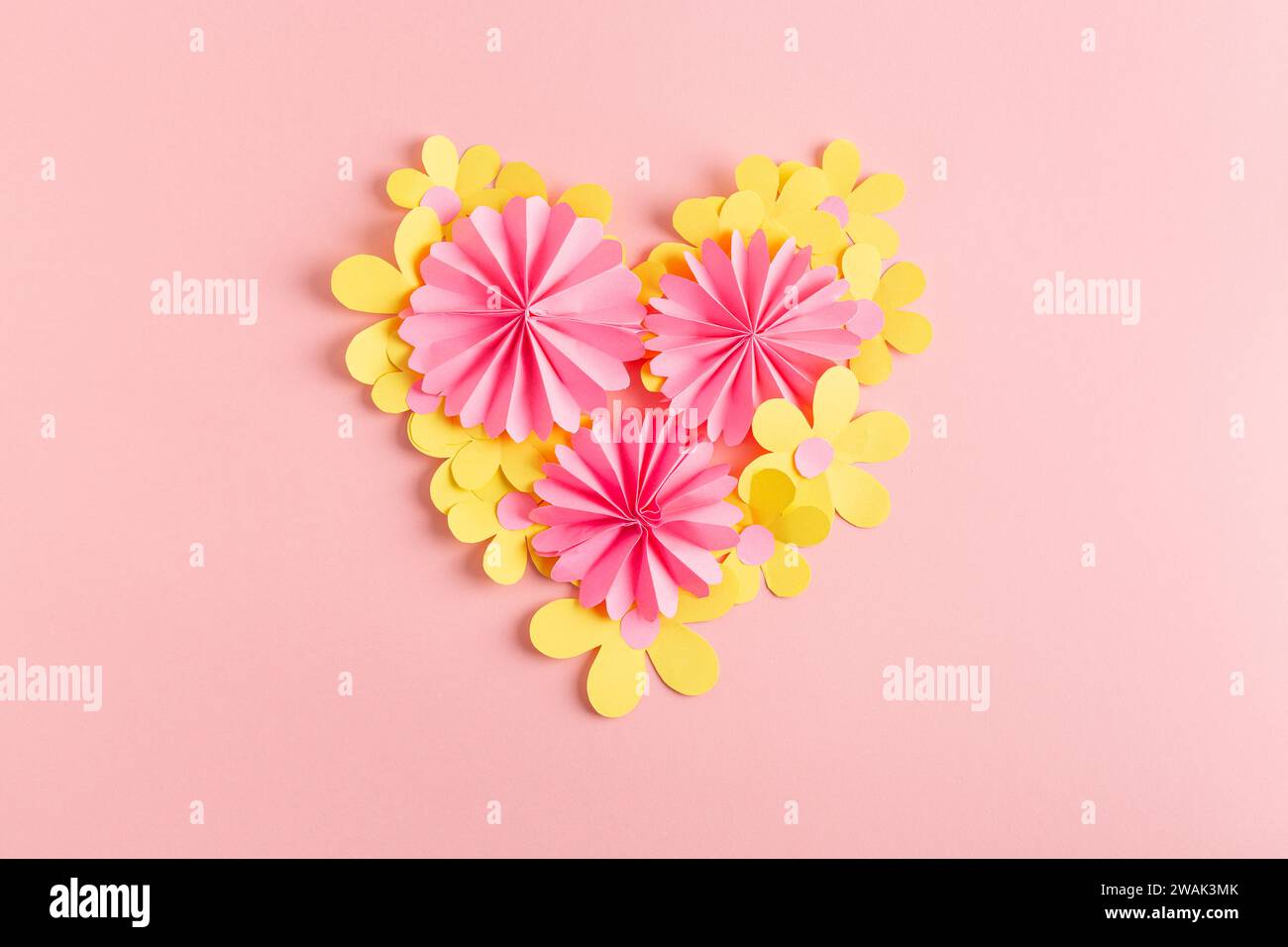 Heart from paper flowers diy with kids craft Stock Photo - Alamy