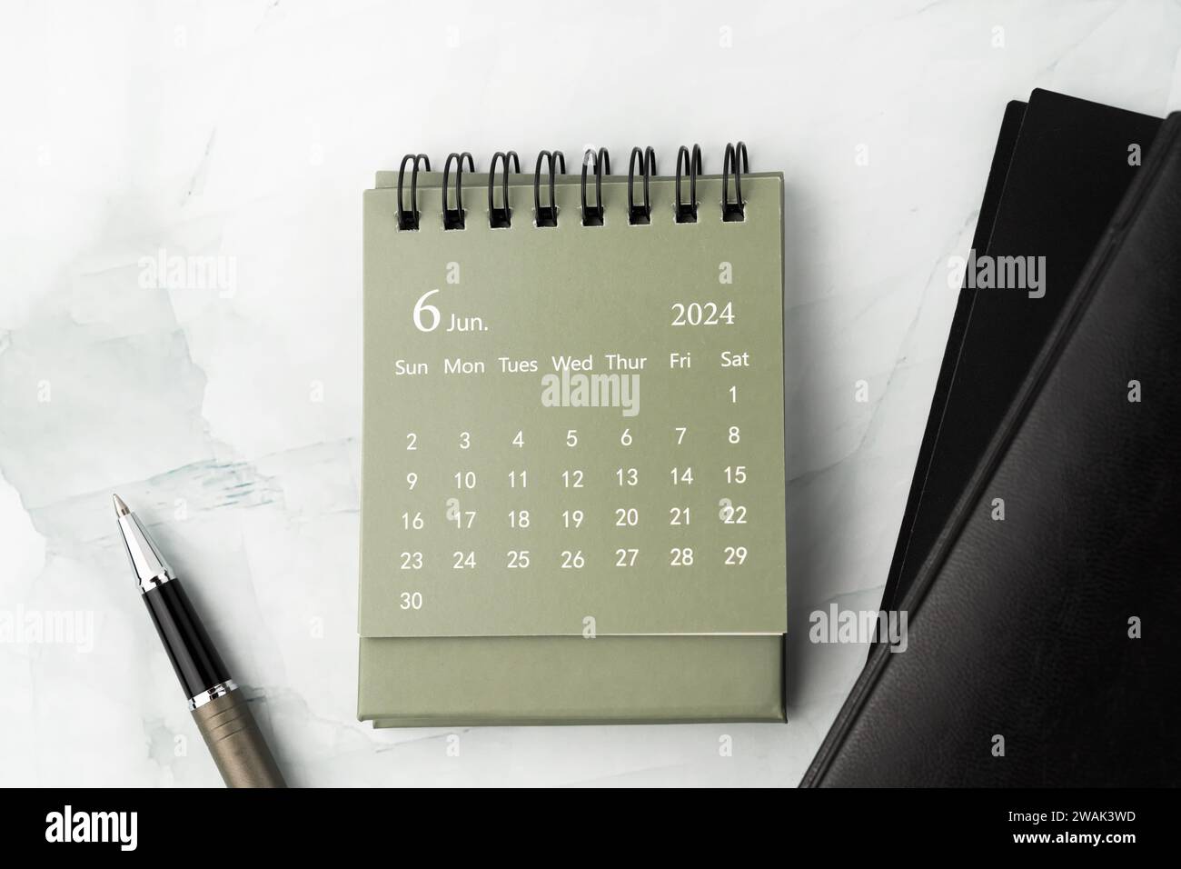 June 2024 desk calendar and notepad flat lay Stock Photo - Alamy
