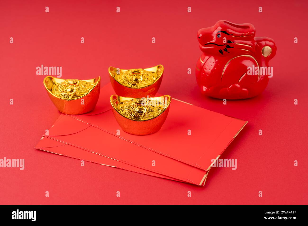 Year of the Dragon with red envelope and gold ingot Stock Photo - Alamy