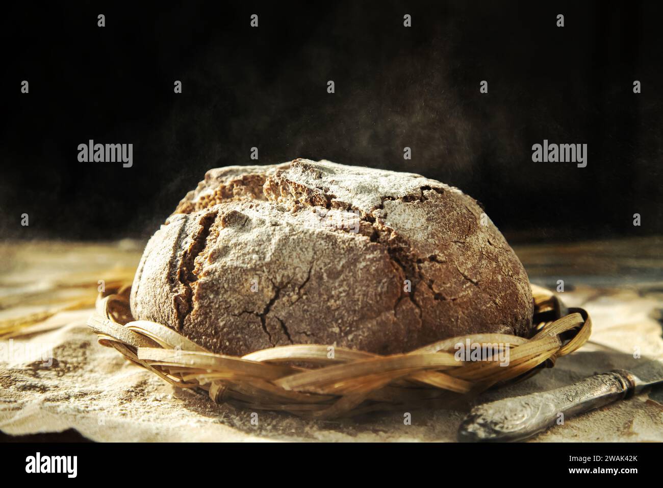 Freshly baked traditional bread in a sprinkle of flour. Yeast-free rye ...