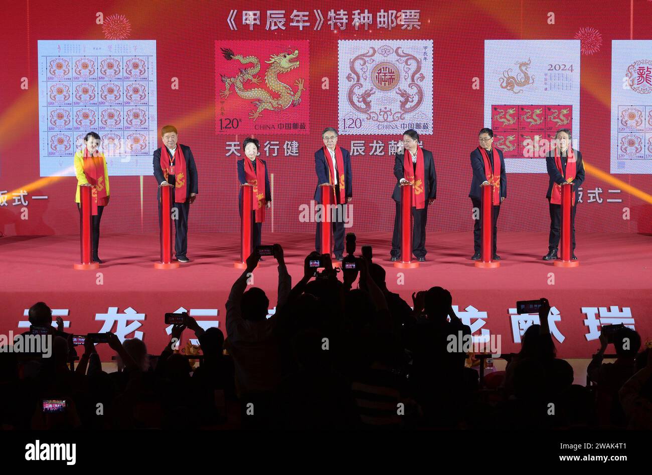 Beijing, China. 5th Jan, 2024. Guests unveil the special stamps marking the Chinese zodiac Year ...