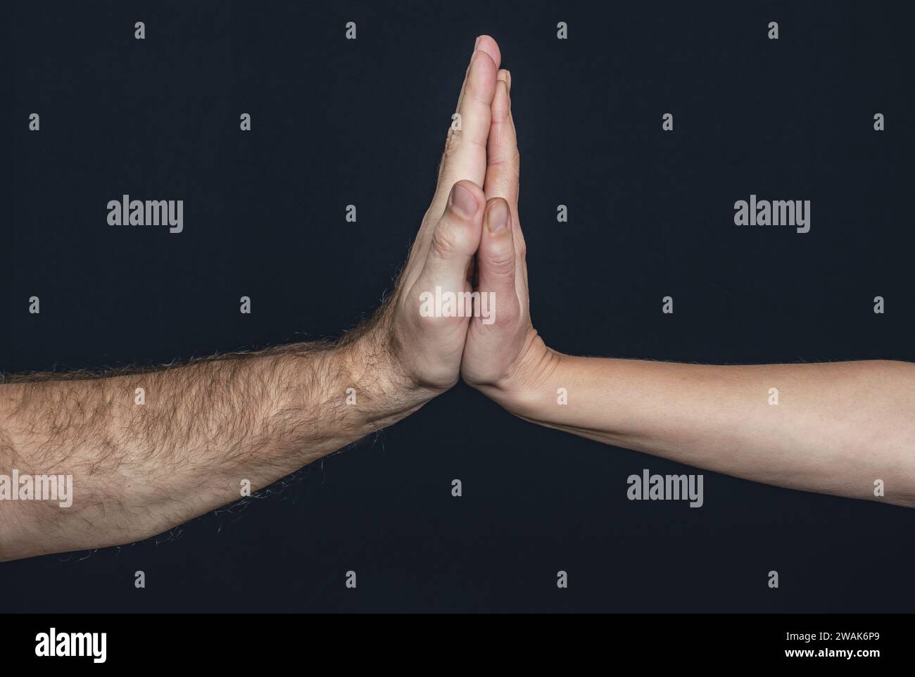 Male and female hands clapping together on black background Stock Photo ...