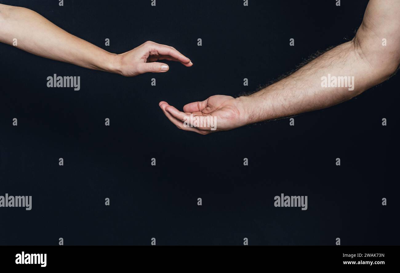 Female palm over male hand on black Stock Photo - Alamy