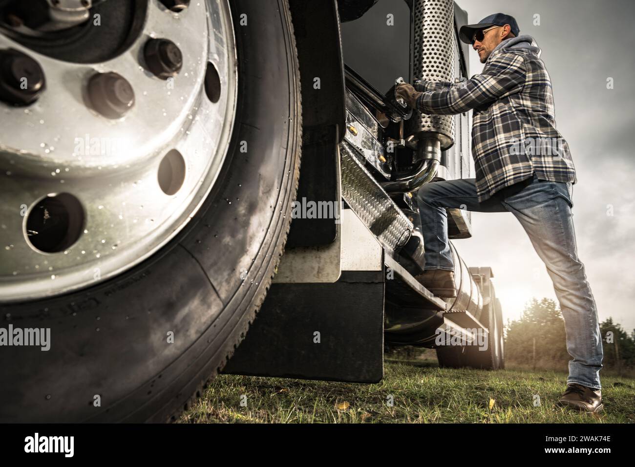 Semi Truck Driver Getting Inside To His Tractor Cabin Preparing For a ...
