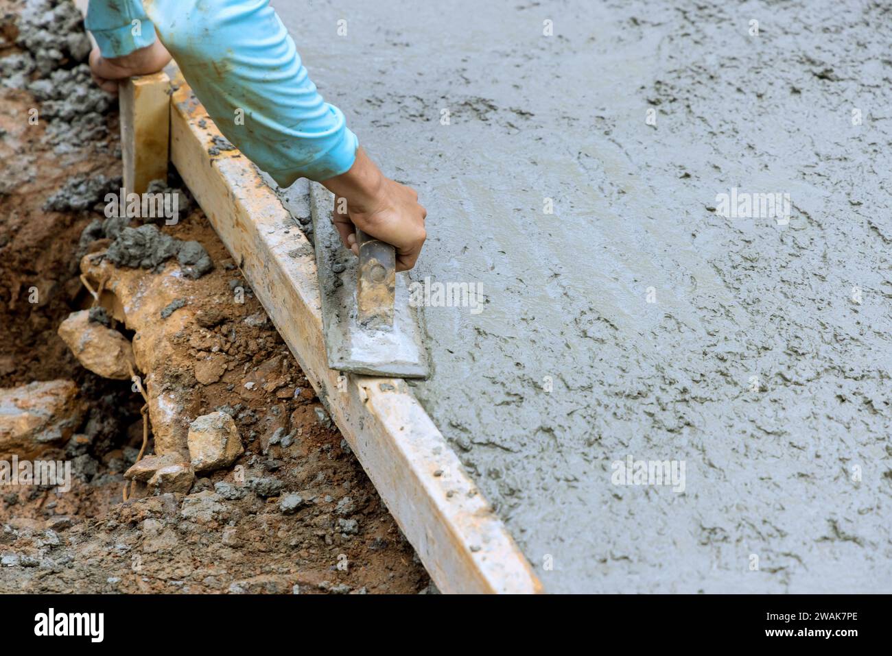 Leveling of new concrete pavement using special working tool by mason ...