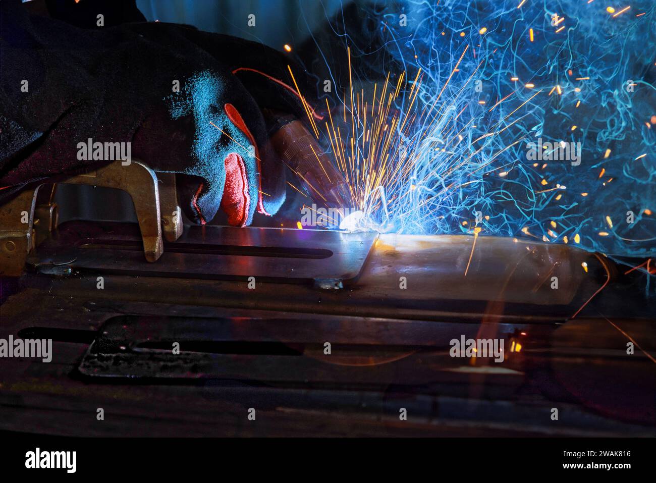 Workers welding steel using argon gas generate sparks that smoke during ...