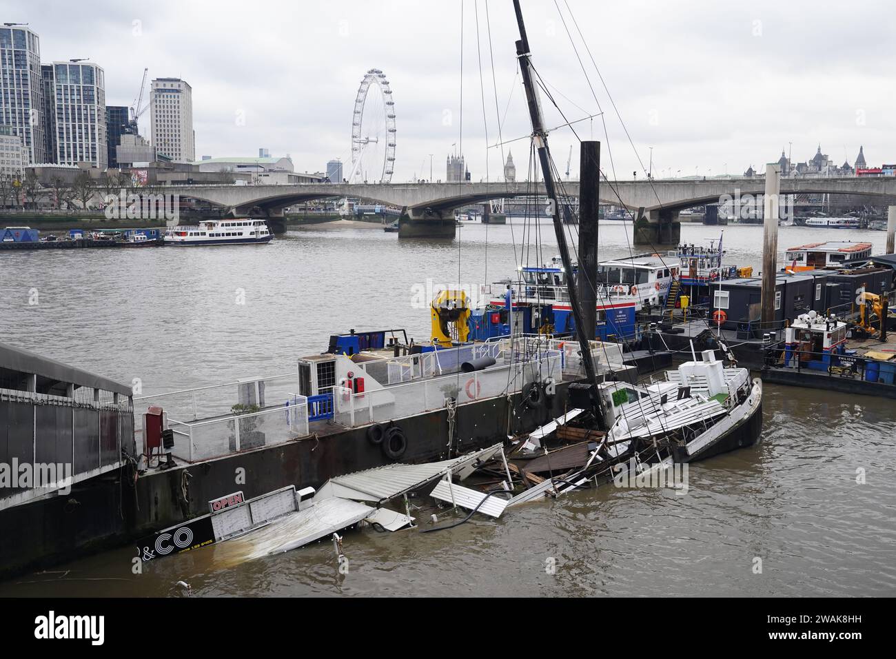The Bar & Co boat, which is moored at Temple Pier, juts from the water ...