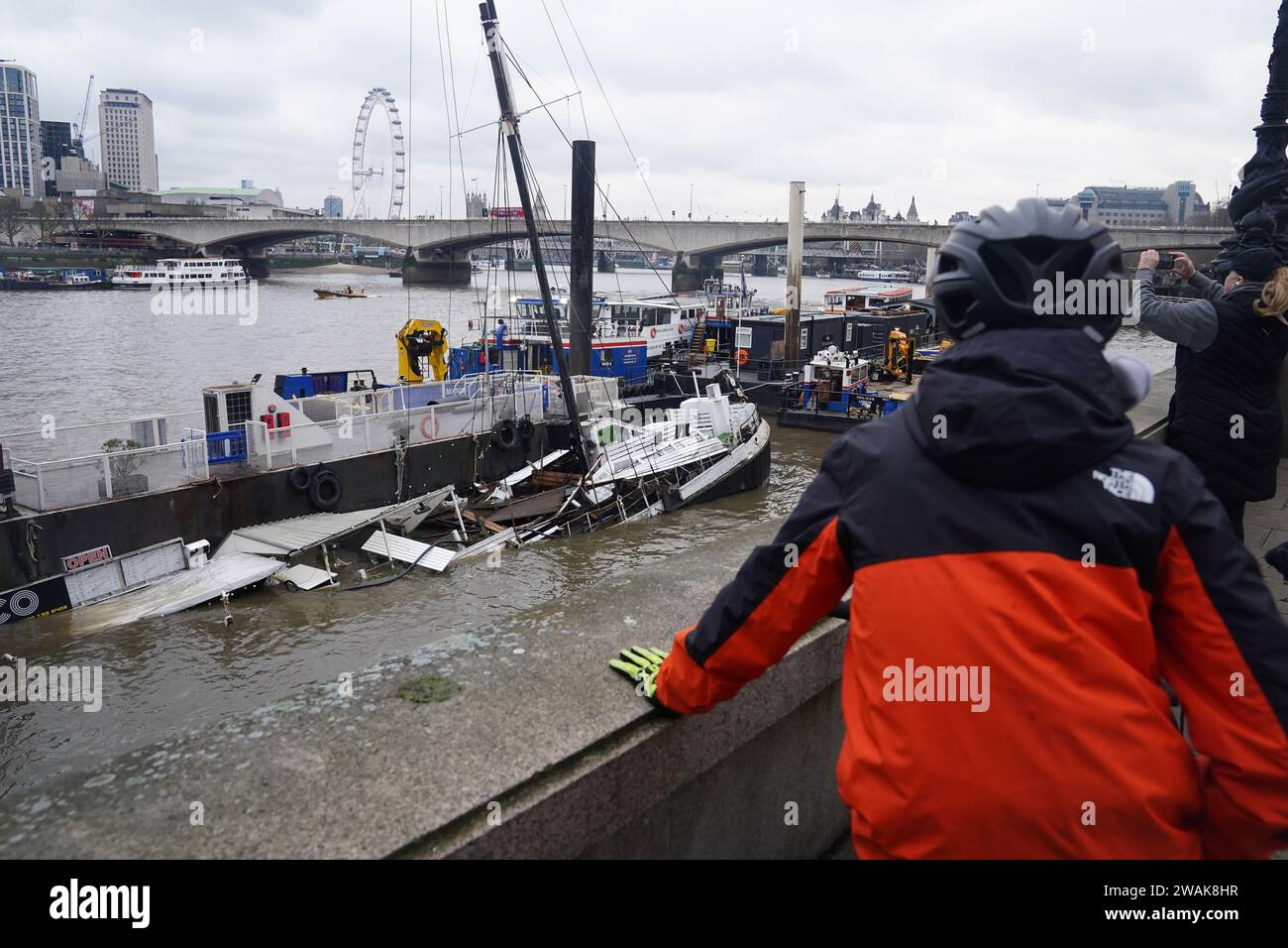 The Bar & Co boat, which is moored at Temple Pier, juts from the water ...