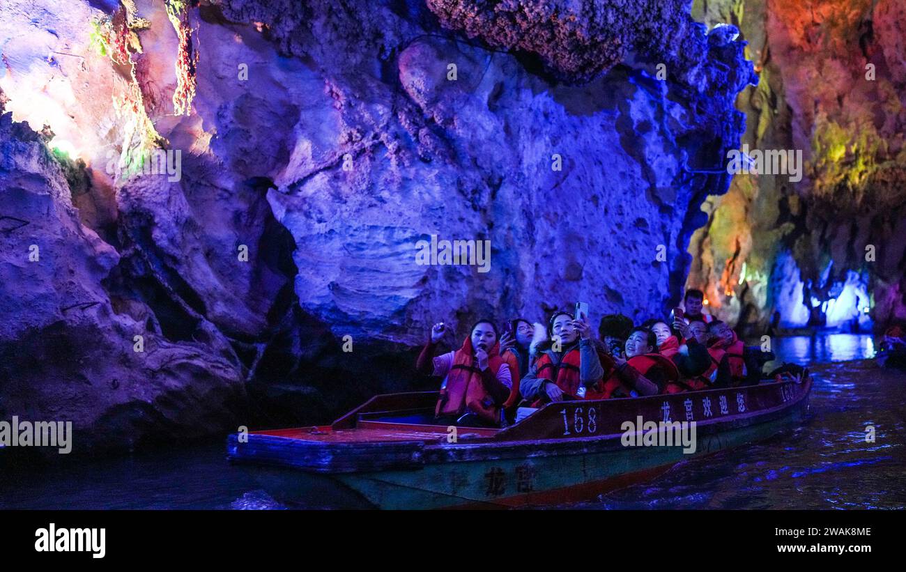 Anshun, China's Guizhou Province. 5th Jan, 2024. Tourists take boats to ...