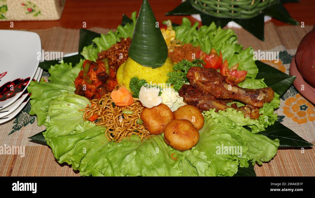 Rice in a cone shape or called Nasi Tumpeng A festive Indonesian rice ...