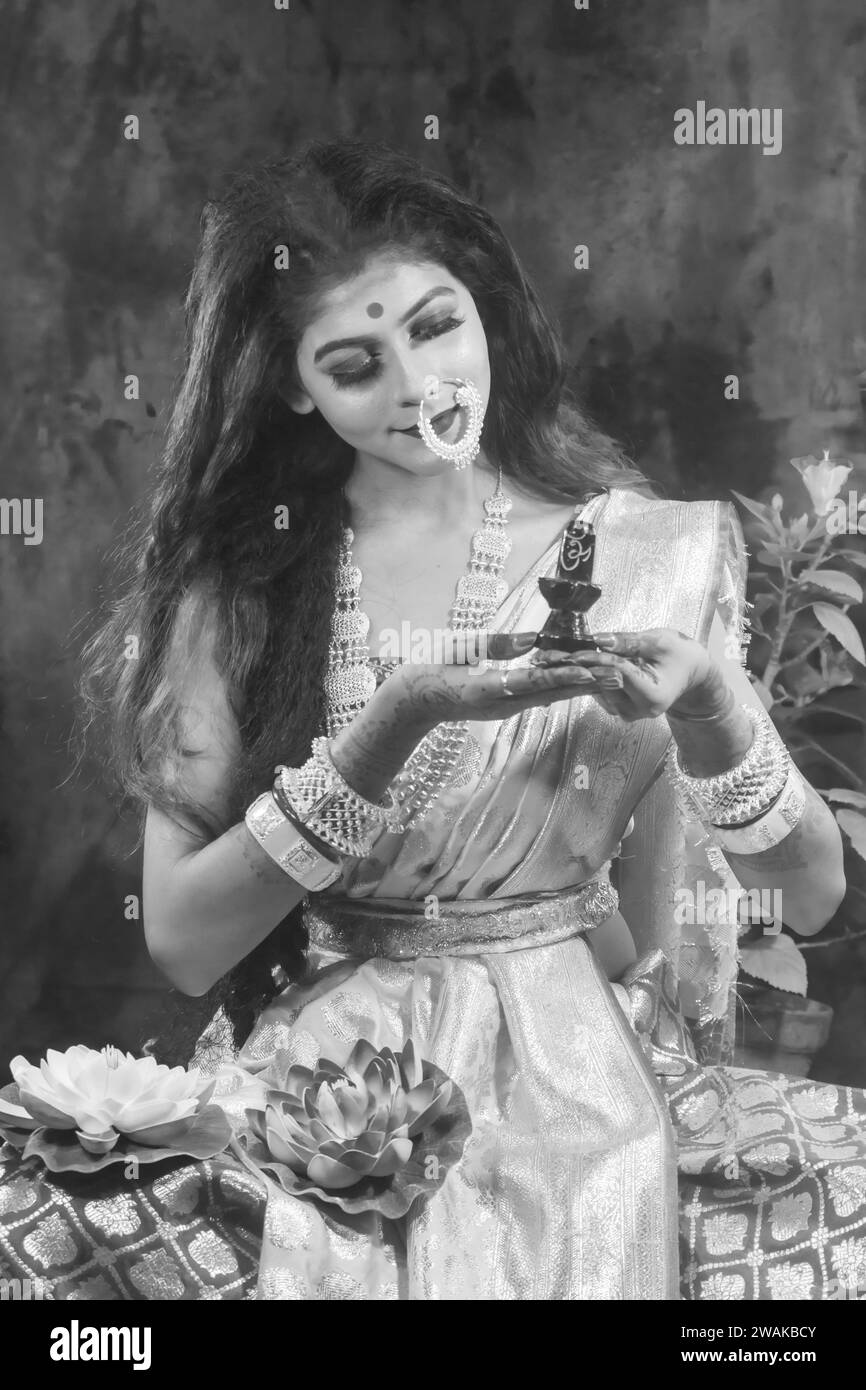 Portrait of a young beautiful woman with posing in front of a printed ...