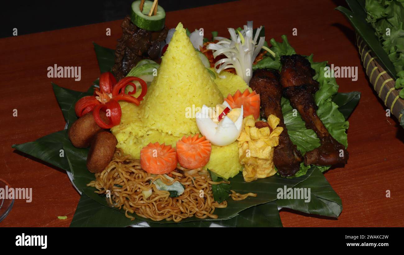 Rice in a cone shape or called Nasi Tumpeng A festive Indonesian rice ...