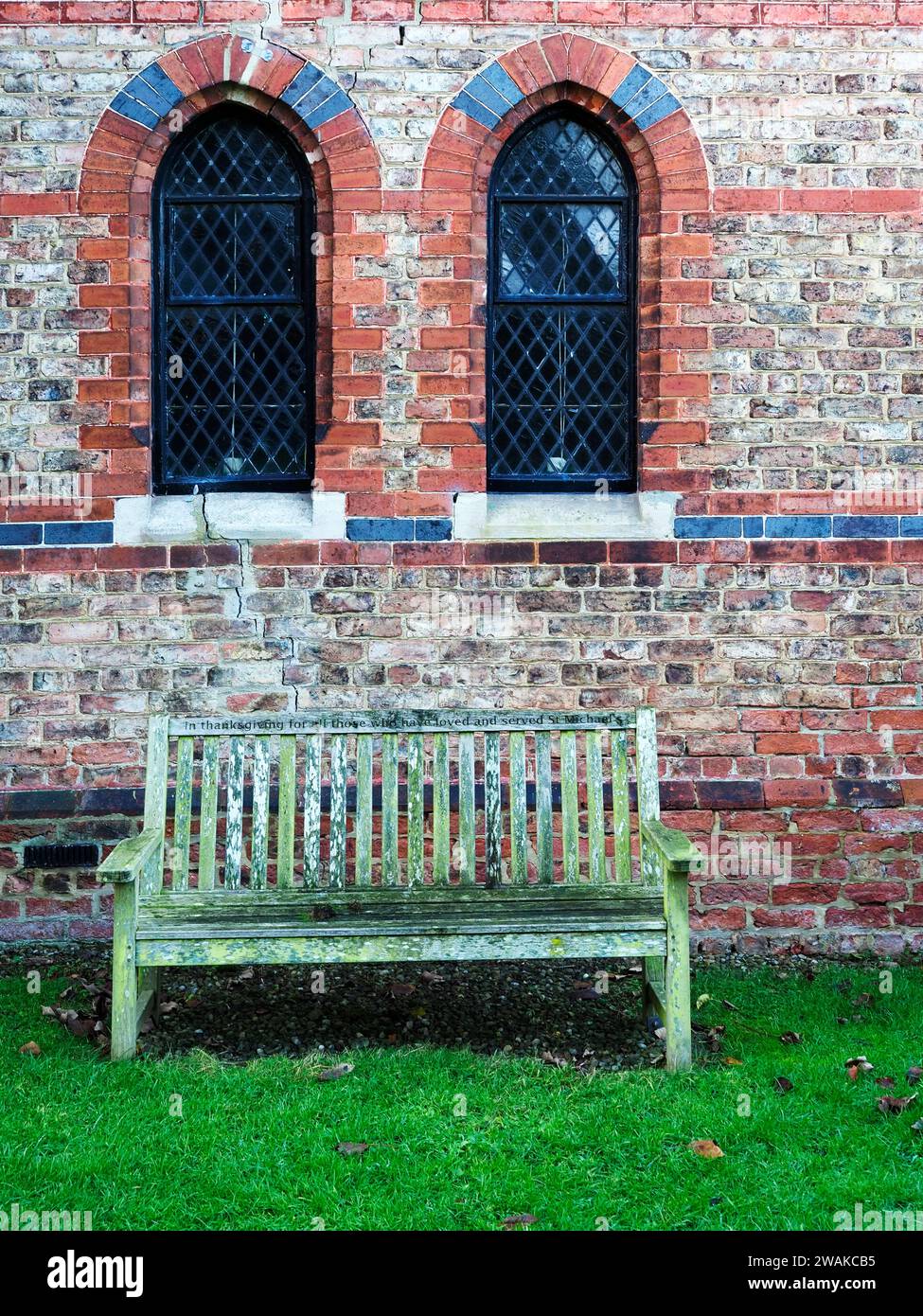 Wooden bench at the church of Saint Michael at Littlethorpe near Ripon ...