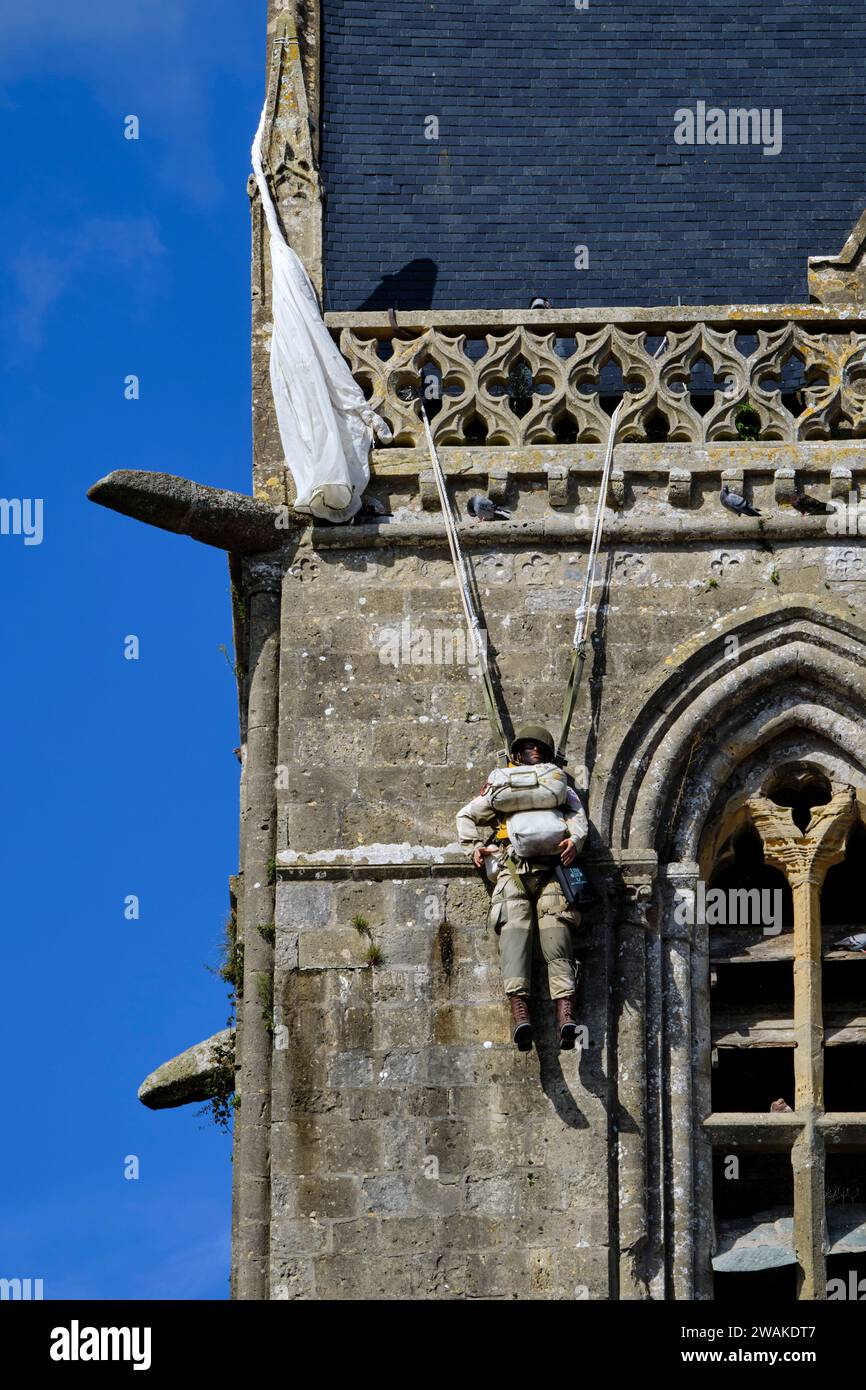 France, Manche, Sainte Mère-Eglise, mannequin of paratrooper John Steele hanging from the church ...