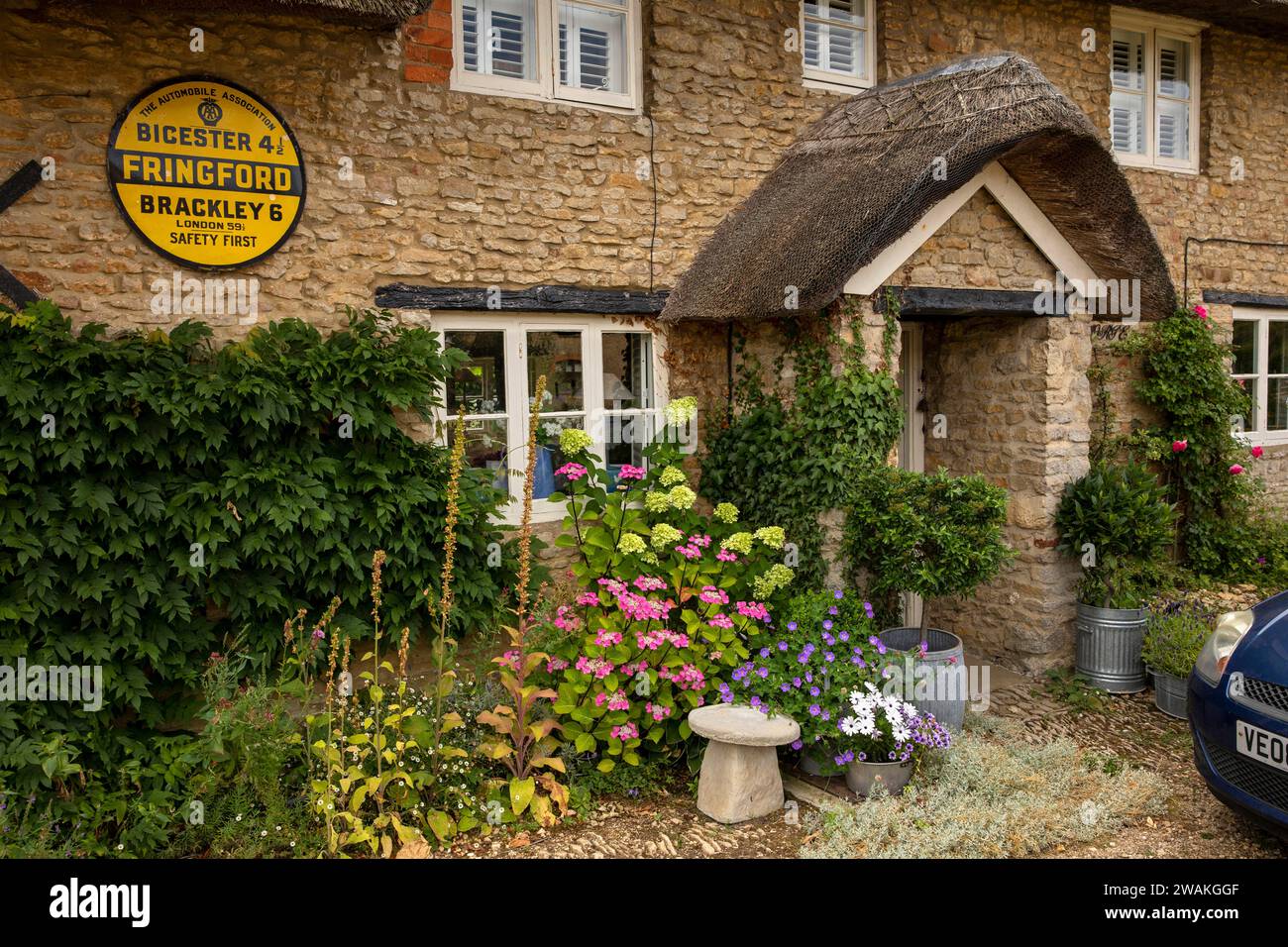 UK, England, Oxfordshire, Fringford, Main Street, AA village sign and ...