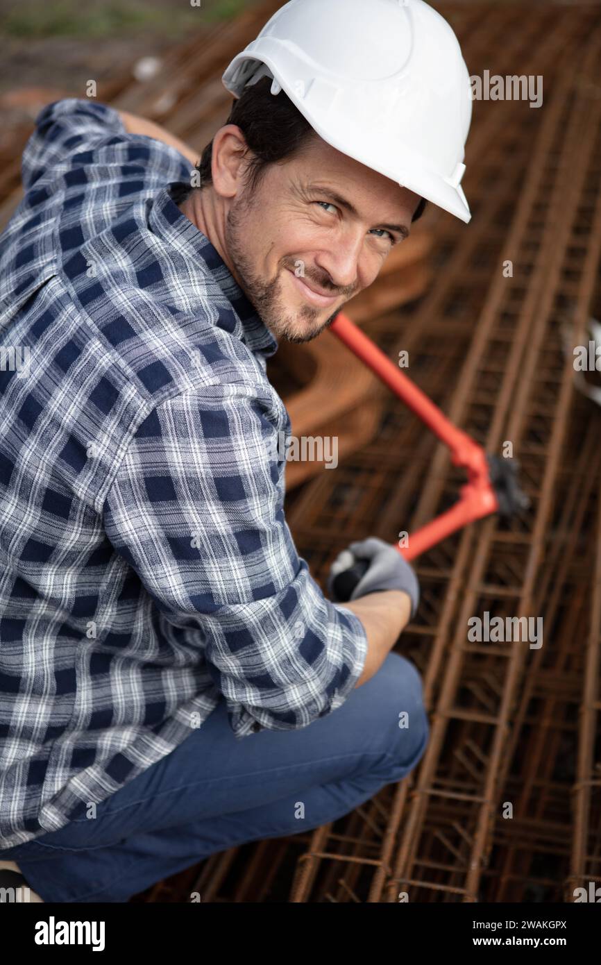 authentic construction worker cutting steel reinforcement bars Stock Photo - Alamy
