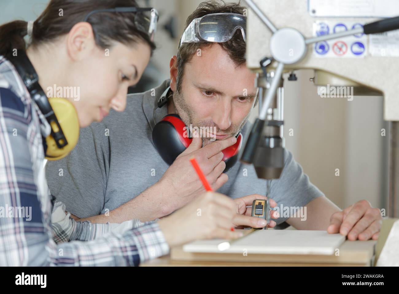 Young man using drill machine hi-res stock photography and images - Alamy