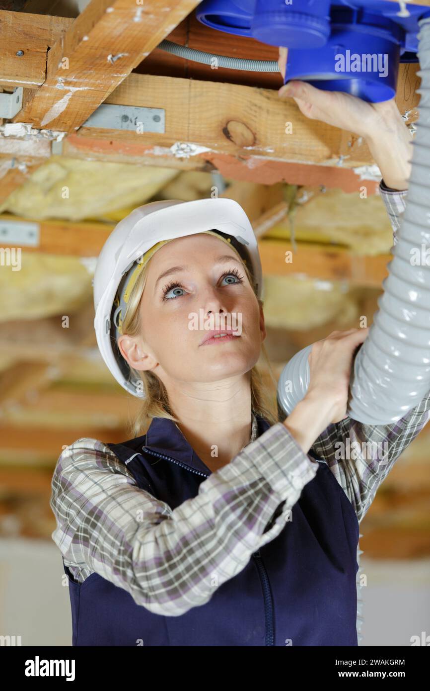 young female worker installing ventilation system Stock Photo - Alamy
